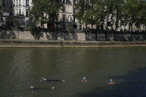Paris mayor dips into the Seine River to showcase its improved ...